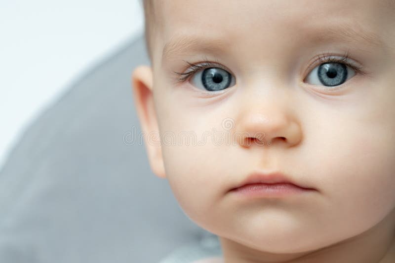 Close Up of a Babys Face with Blue Eyes, Looking at the Camera Stock ...