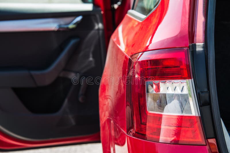 Close Up of a Back Car Light. Red Car with Open Side Door and Trunk ...