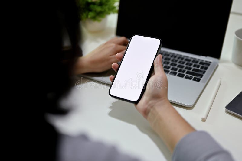 Close-up, Back View of a Female Worker Using Her Smartphone at Her Desk ...