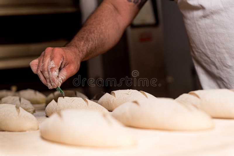 Close Up of Baker Hand Cutting and Decorating Fresh Bread Dough before ...