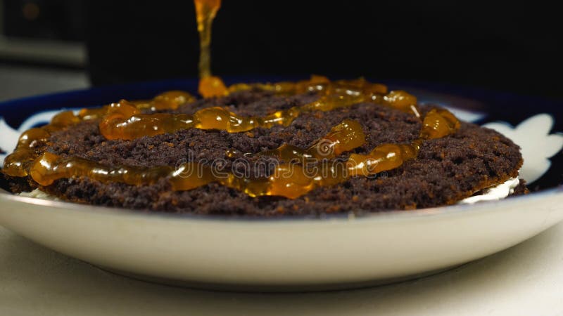 Close-up of the Baker Putting Jam on the Dark Sponge Cake. Soaking the ...