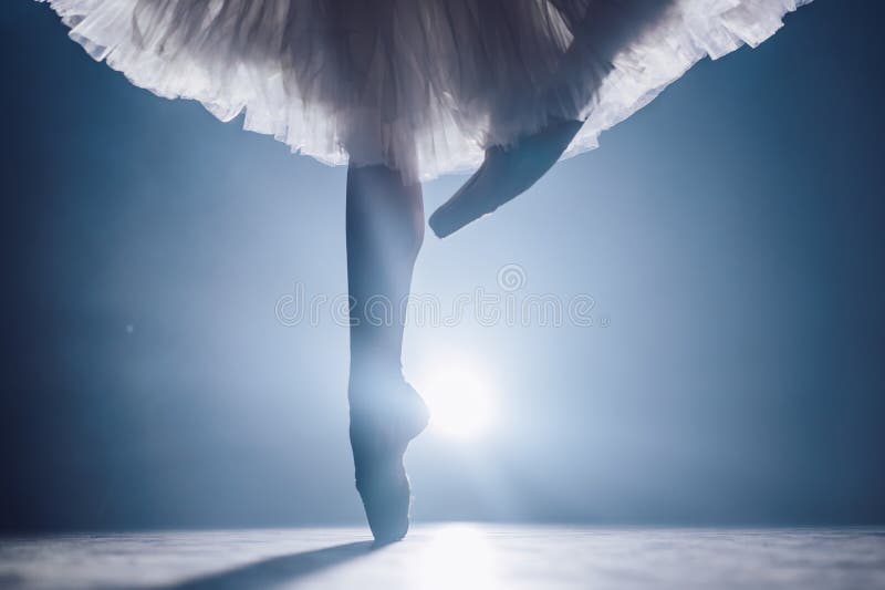 Close Up Of Ballet Dancer As She Practices Exercises On Dark Stage Or