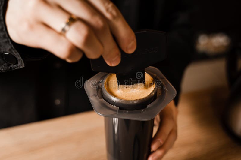 Close-up Barista Brews Aeropress Coffee and Stirs it Inside. Process of ...