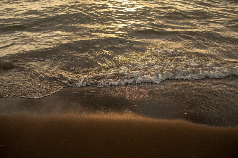 Close Up Beach Wave at Sunset. Sun Reflecting on Serene Beach Stock ...