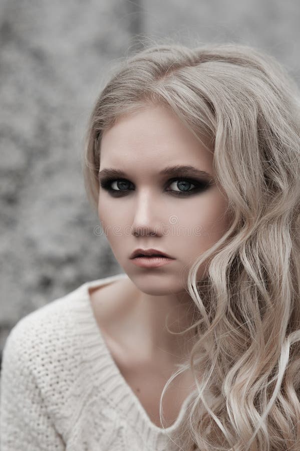 Close Up Of Beautiful Young Blonde Woman With Blue Eyes In White