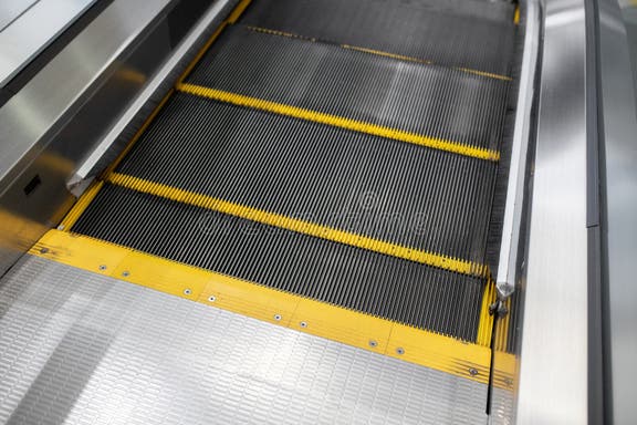 Close-up of the Beginning of the Escalator. Yellow Restrictive Notches ...