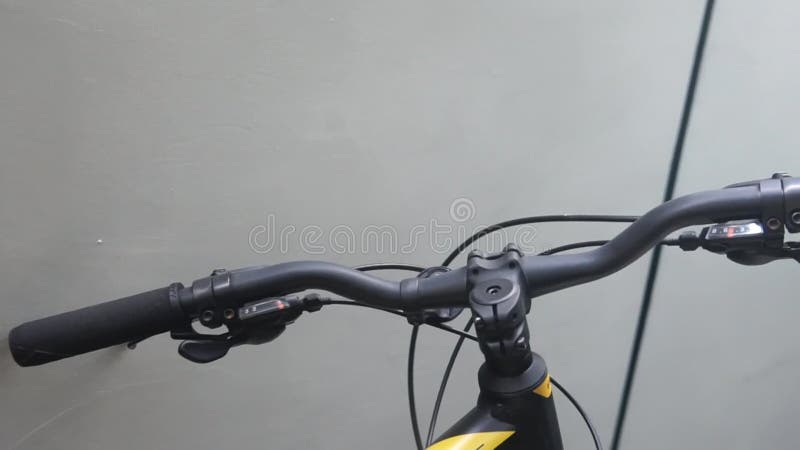 Close-up of a Bicycle Handlebar Featuring a Striking Yellow and Black ...