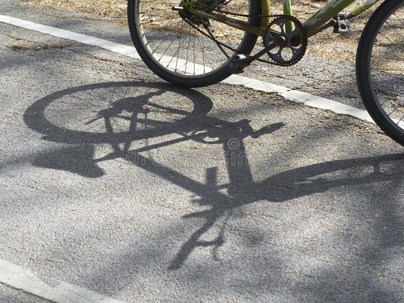 Close Up Bicycle and Shadow on Road Stock Photo - Image of morning ...