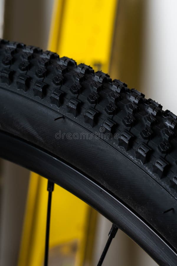 Close Up Bicycle Tire on Yellow Bike Rack in Workshop Stock Image ...