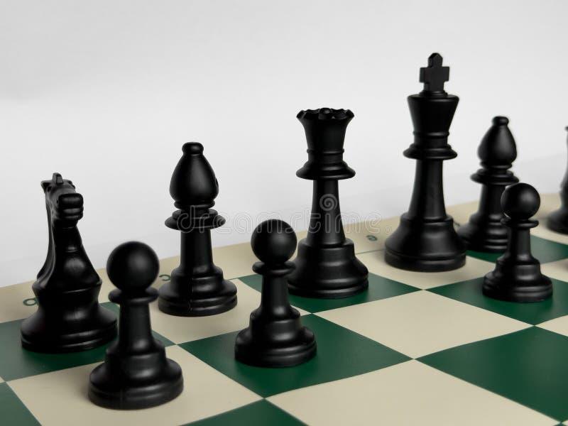 Close Up of Black Chess Pieces on Green and White Checkered Board Stock ...