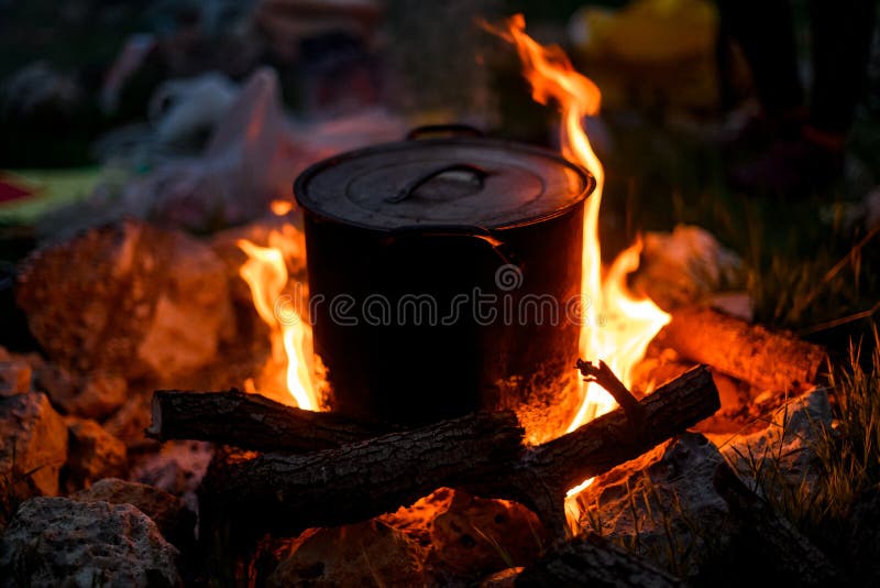 Close-up on Black Iron Pot on Fire. the Concept of Camping Life. Stock ...