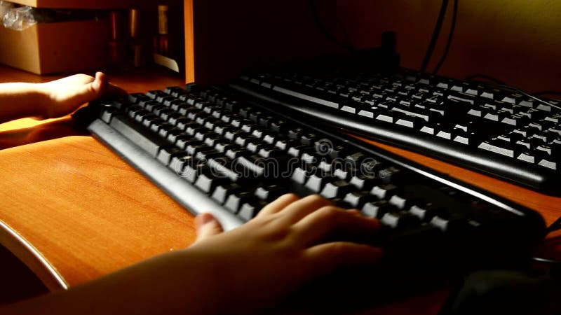 Close-up of a Black Keyboard on a Wooden Table, a Small Child`s Hands ...