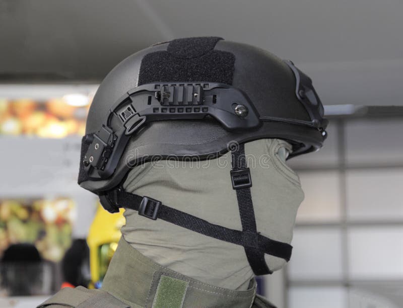 Black Military Combat Helmet On The Green Doll And Blurry Background ...