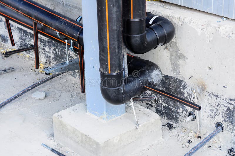 Detailed View of Plastic Pipes Entering a Concrete Foundation at an ...