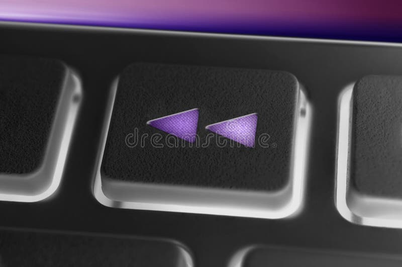 Close Up of a Black Rewind Button of a Black Remote Control with ...