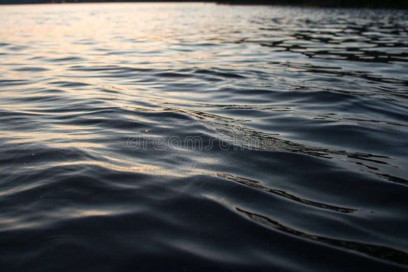 Close-Up of Black Water Surface with Subtle Wave Patterns and Soft ...