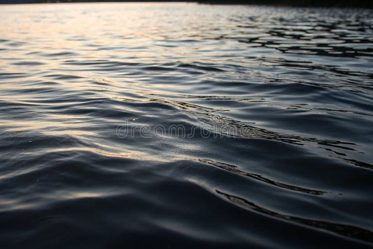 Close-Up of Black Water Surface with Subtle Wave Patterns and Soft ...