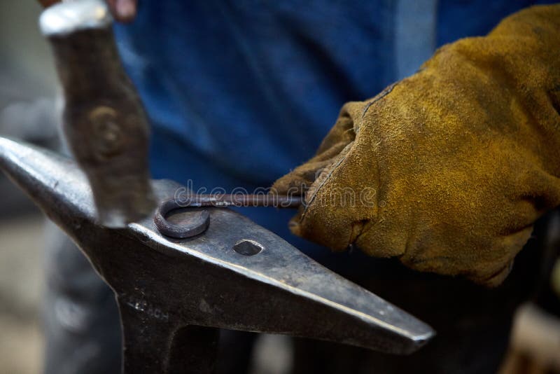 Close-up of a Blacksmith`s Hands Manipulating a Metal Piece Above His ...