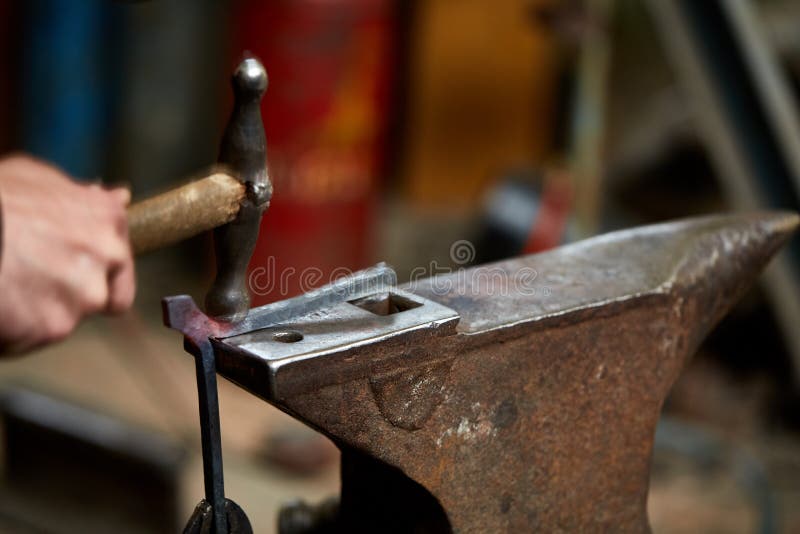 Close-up of a Blacksmith`s Hands Manipulating a Metal Piece Above His ...
