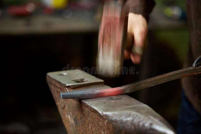 Close-up of a Blacksmith`s Hands Manipulating a Metal Piece Above His ...
