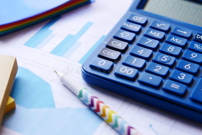 Close Up of Blue Calculator and Financial Chart on Table. Stock Photo ...