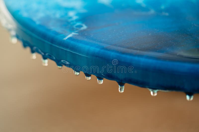 Close Up of Blue Epoxy Resin Drying on Canvas, Droplets Flowing from ...
