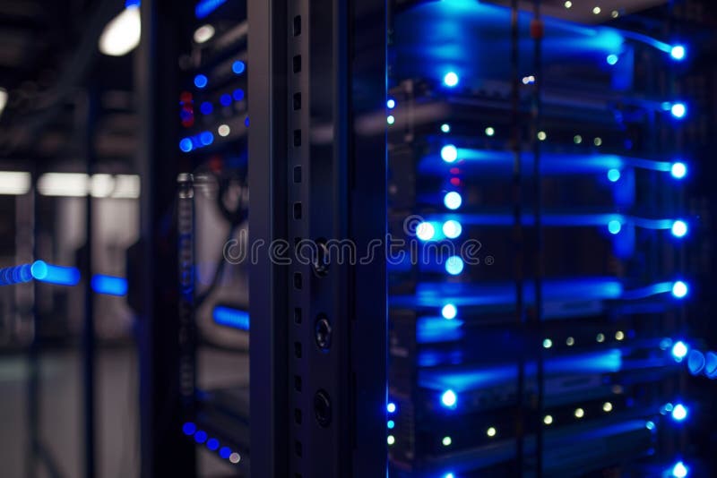Close-up of Blue-lit Server in a Blurred Data Center Background ...