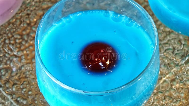 Close Up of Blue Pudding Desserts on a Glass Topped with Cherries Stock ...