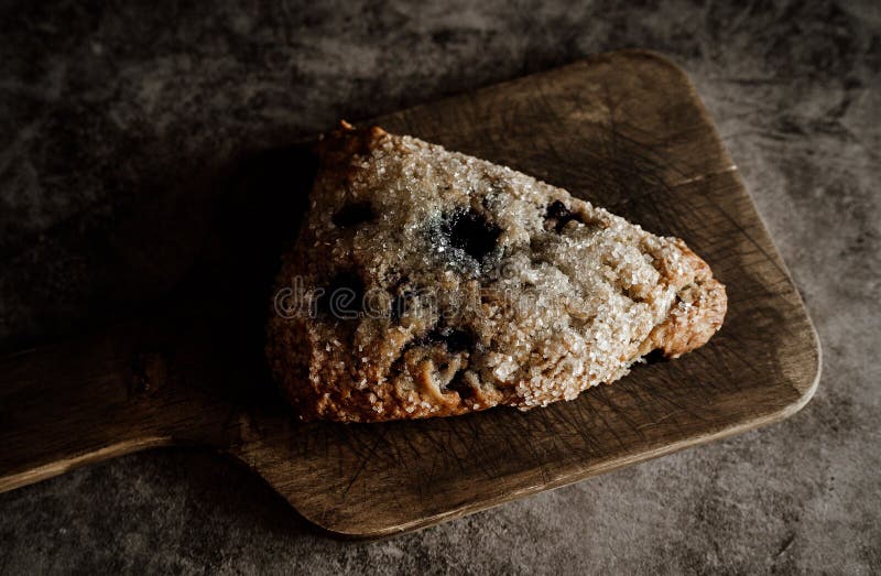 Close-up of a Blueberry Scone on a Rustic Wooden Board, with a Dark ...