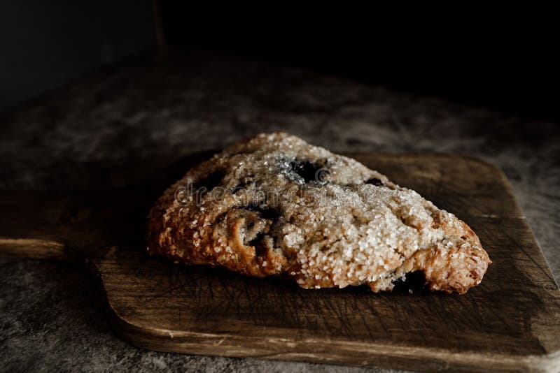 Close-up of a Blueberry Scone on a Rustic Wooden Board, with a Dark ...