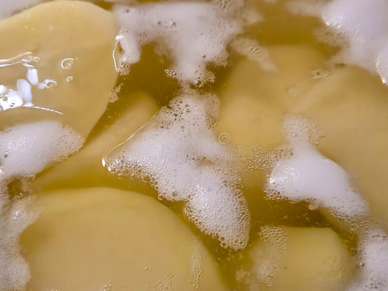 Close-up of Boiling Potatoes in Water Creating Bubbles, Highlighting ...