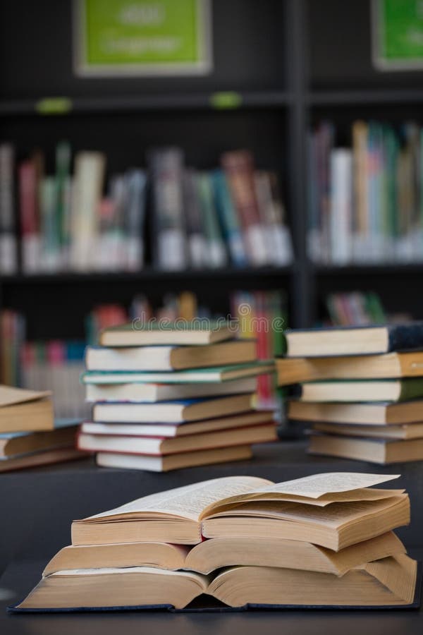 Close Up of Books Stack on Table Against Shelf Stock Image - Image of ...