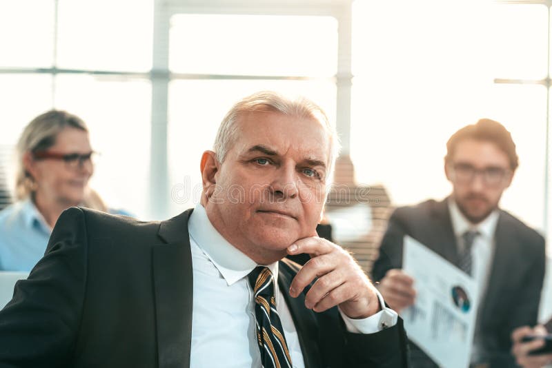 Close Up. Boss Sitting in Front of His Desk Stock Image - Image of ...