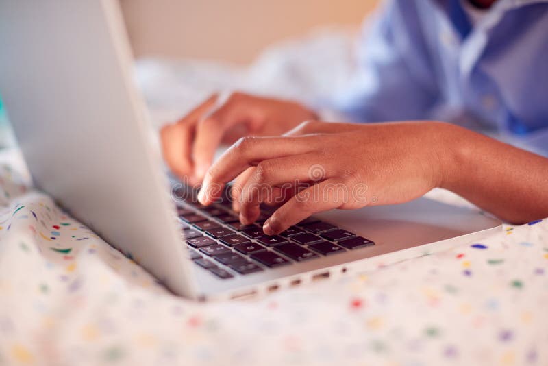 Close Up of Boy in Bedroom Typing on Keyboard of Laptop Stock Image ...