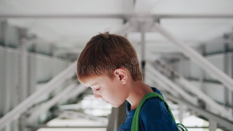 Close-up of a Boy Looking Down Standing Under a Bridge. Stock Video ...