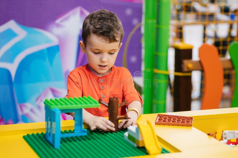 Close-up of a Boy S Child Playing with Colorful Plastic Bricks at a ...