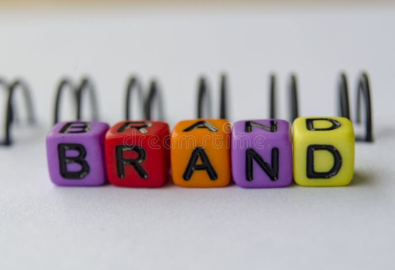 Close Up of BRAND Text Representing on Small Square Toy on White ...