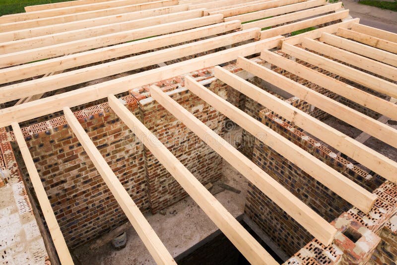 Close Up of a Brick House with Wooden Ceiling Frame Under Construction ...