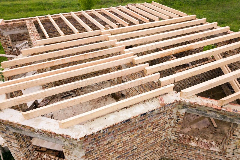 Close Up of a Brick House with Wooden Ceiling Frame Under Construction ...