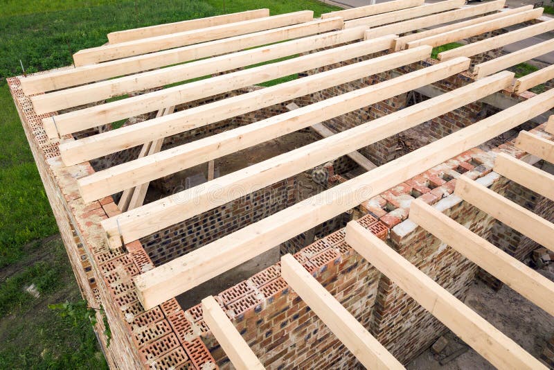 Close Up of a Brick House with Wooden Ceiling Frame Under Construction ...