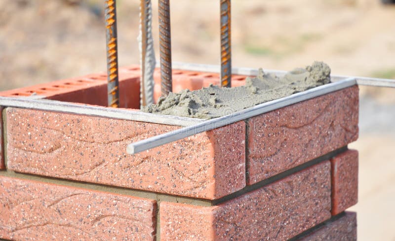 Bricklaing Brick Pillar with Iron Bars. Stock Photo - Image of ...