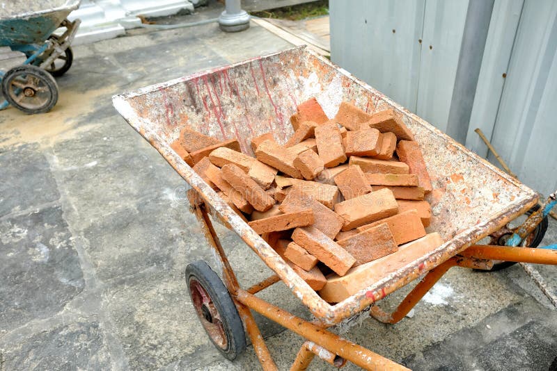 Bricks in a wheelbarrow stock photo. Image of cubes - 165097294