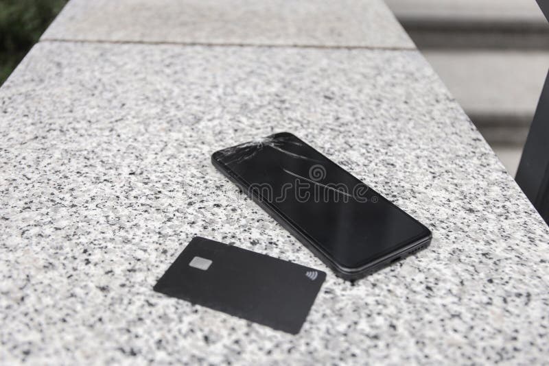 Close Up of Broken Phone with Plastic Card on Paved Sidewalk Outdoors ...