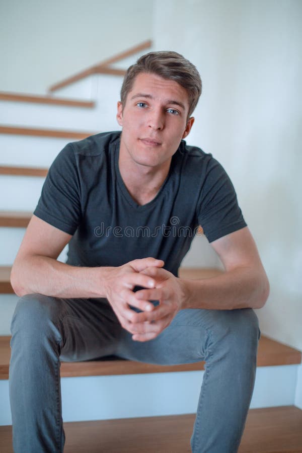 Brooding Handsome Guy Reading a Message on His Smartphone. Stock Image ...