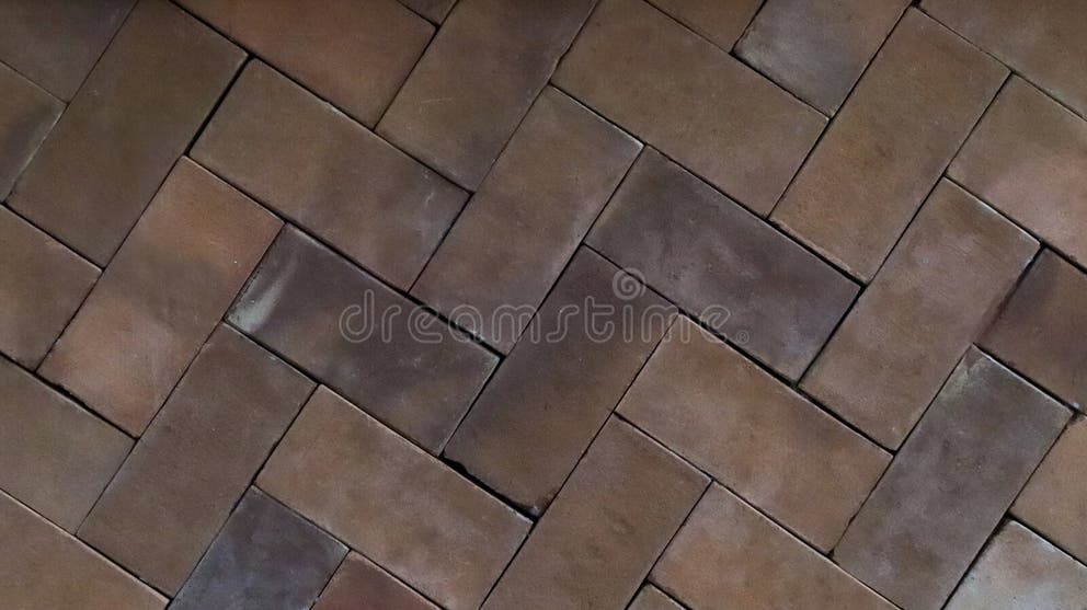 Close-up of Brown Interlocking Brick Floor Pattern with a Rustic ...