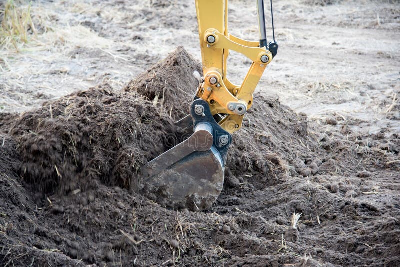 A 4x4 Backhoe Loader, Dumping Dirt into a Commercial Dump Truck Stock ...