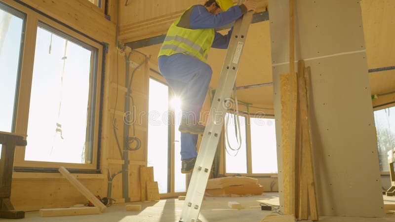 CLOSE UP: Builder Climbs Down from Stepladder Placed Inside ...