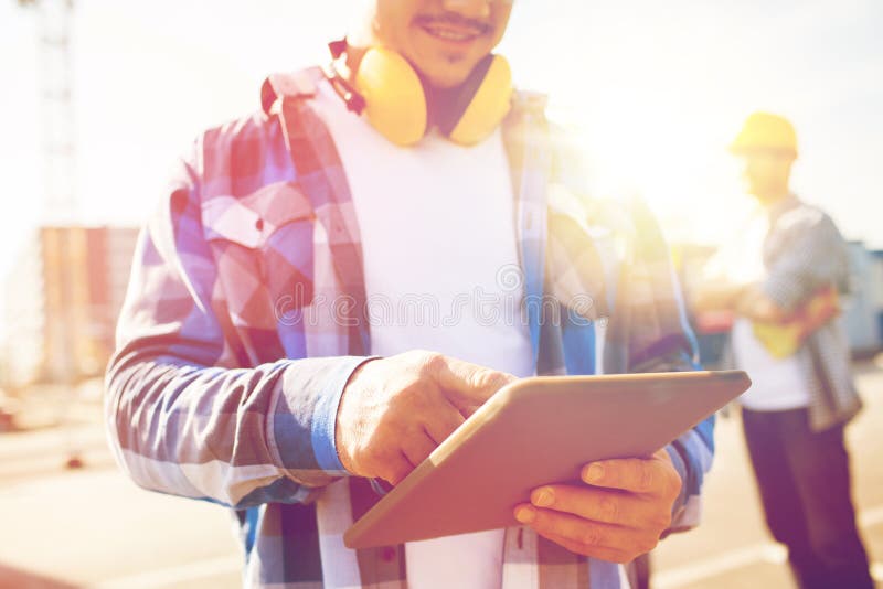 Close Up of Builder with Headphones and Tablet Pc Stock Image - Image ...