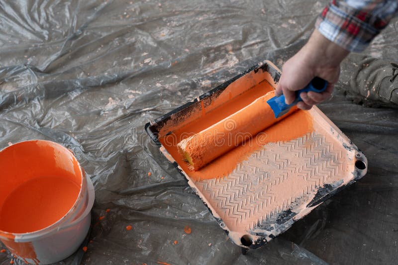Close-up of a Builder Using Paint Roller in His Work Indoors, Picks-up ...