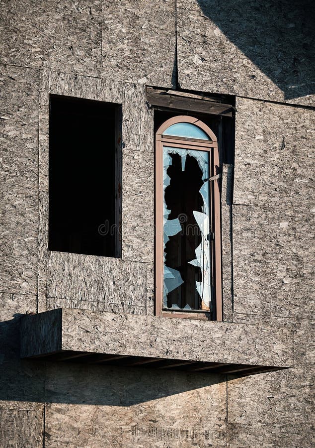 A Close-up of a Building Under Construction, Featuring a Broken Window ...